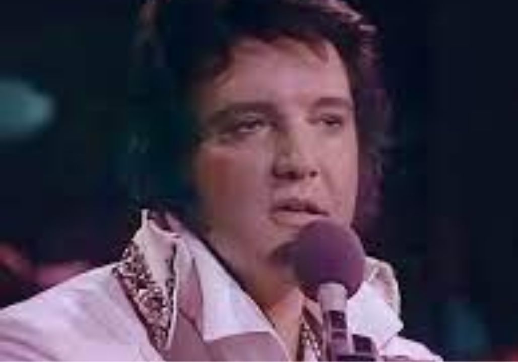 Elvis Presley—his body heavier, his face worn with fatigue—commanded ...